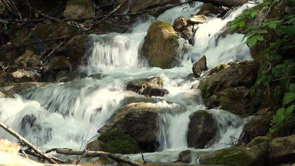 Clean fresh water of a forest stream running over rocks - Stock Video ...