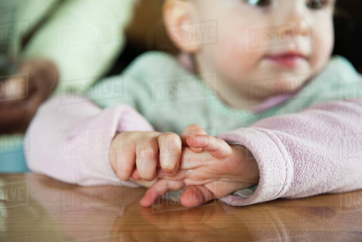 Baby girl's clasped hands - Royalty-free Stock Photo | Dissolve