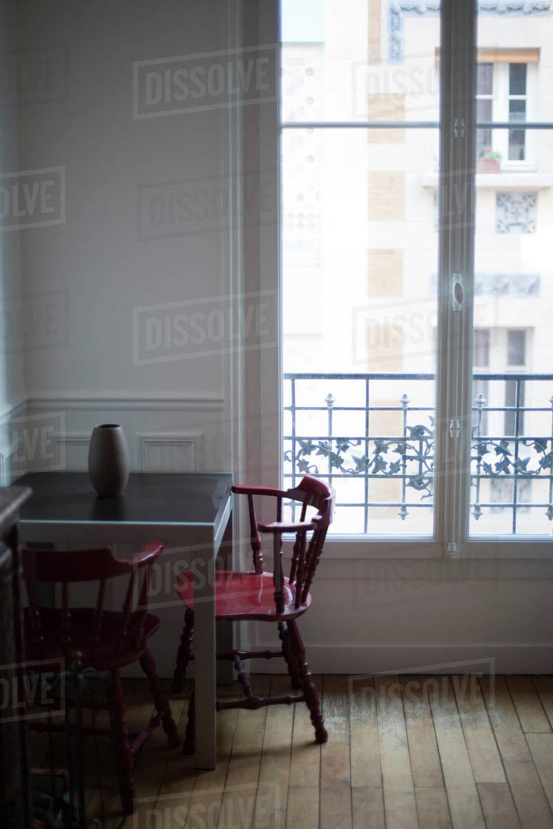 Table and chairs by window - Stock Photo - Dissolve