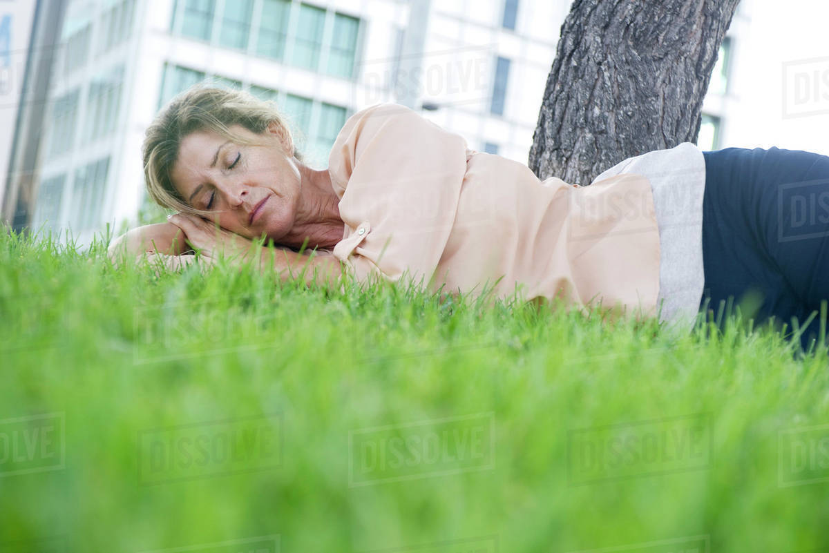 Woman napping in grass - Royalty-free Stock Photo | Dissolve