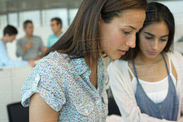 Female colleagues working together in office - Stock Photo - Dissolve