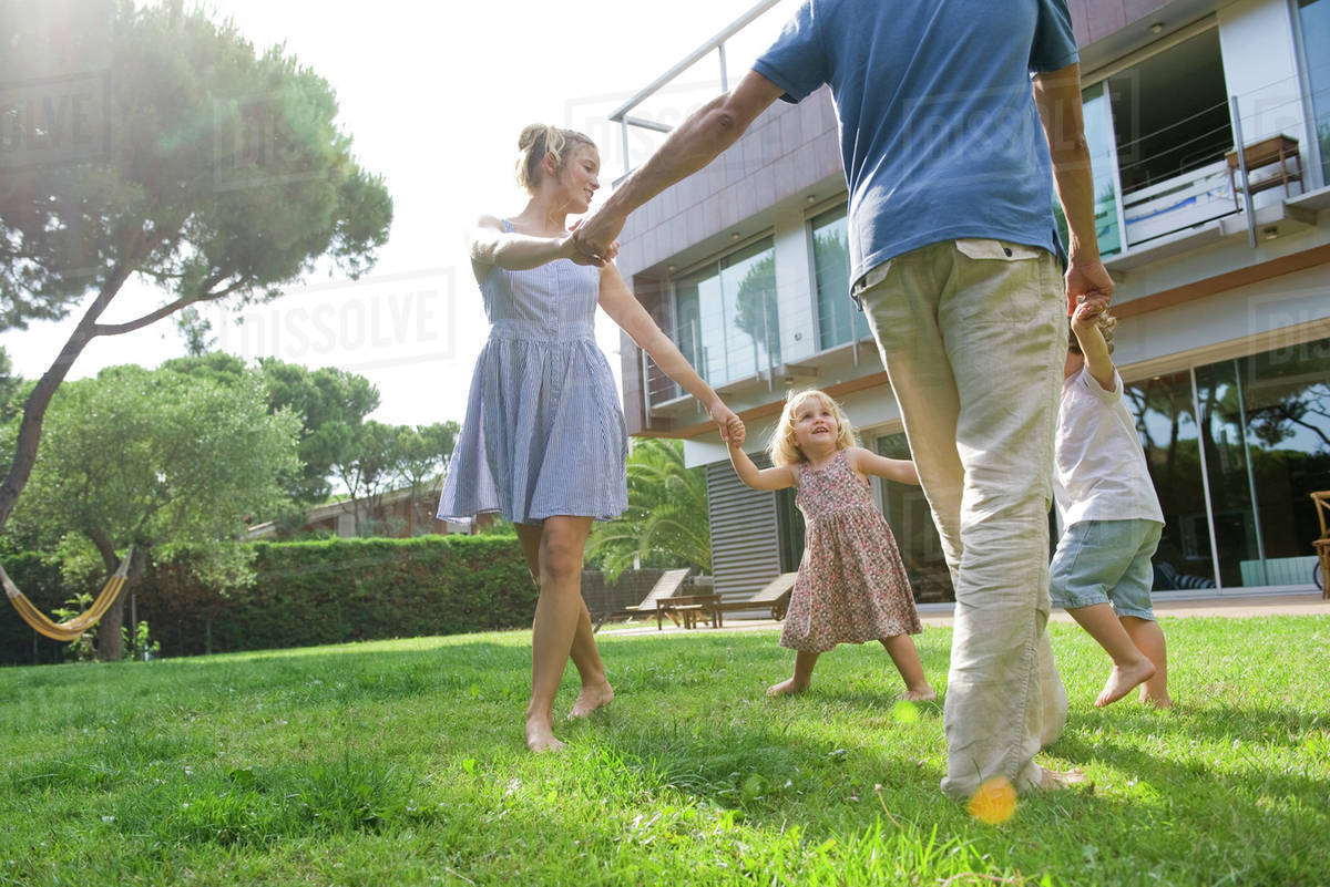 Family playing ring-around-the-rosy outdoors - Royalty-free Stock Photo ...