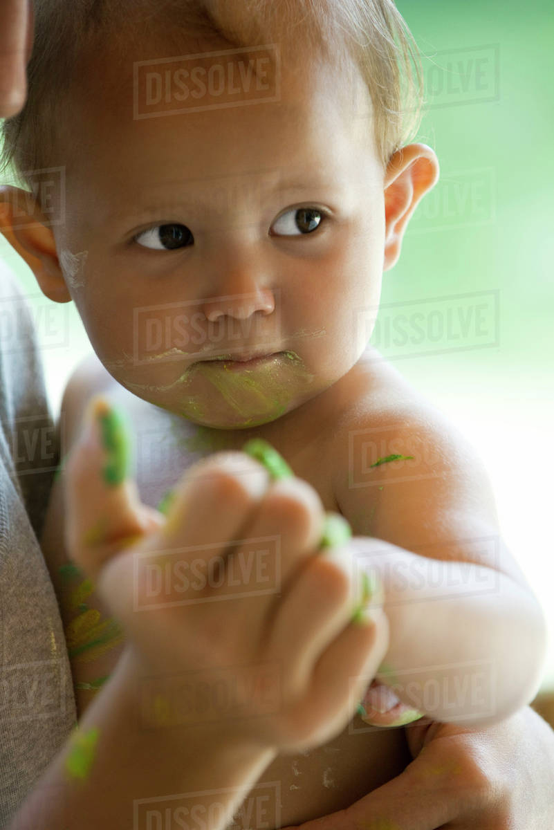 Baby touching mother's hand - Royalty-free Stock Photo | Dissolve