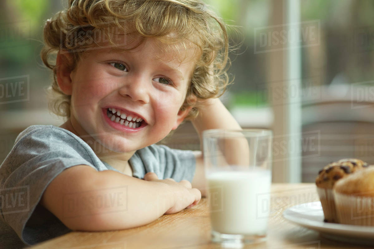 Little boy sitting at table with snack, portrait - Royalty-free Stock ...