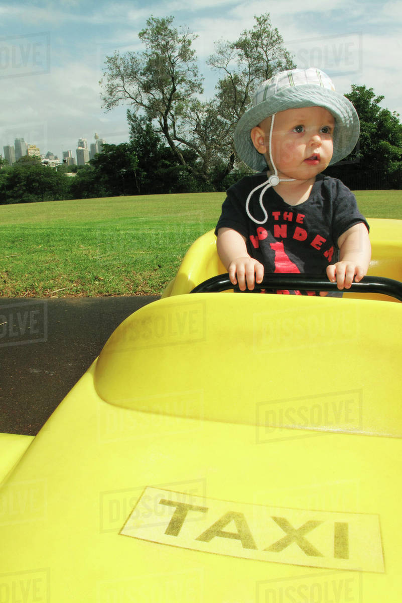 Baby riding in pretend taxi - Royalty-free Stock Photo | Dissolve