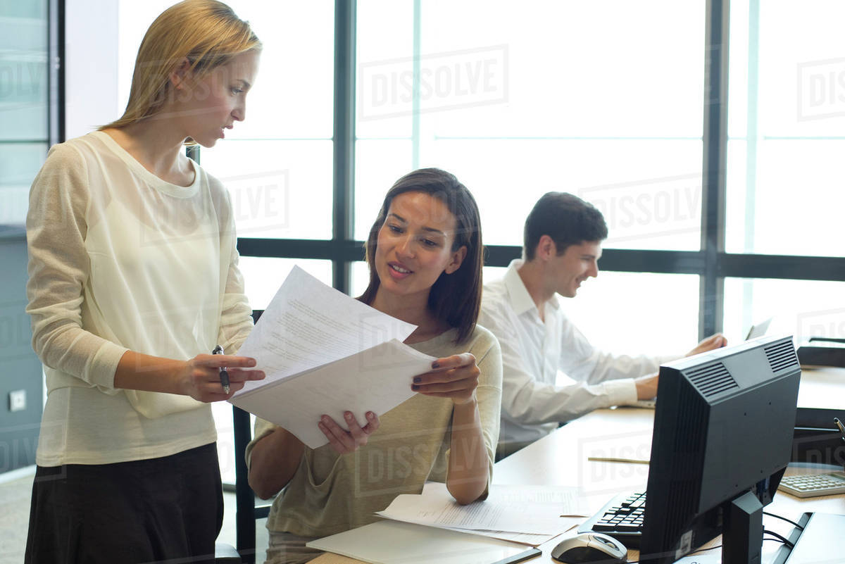 Colleagues reviewing documents together - Royalty-free Stock Photo ...