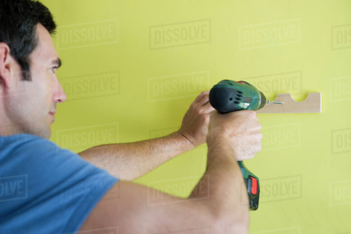 Man using power drill - Royalty-free Stock Photo | Dissolve