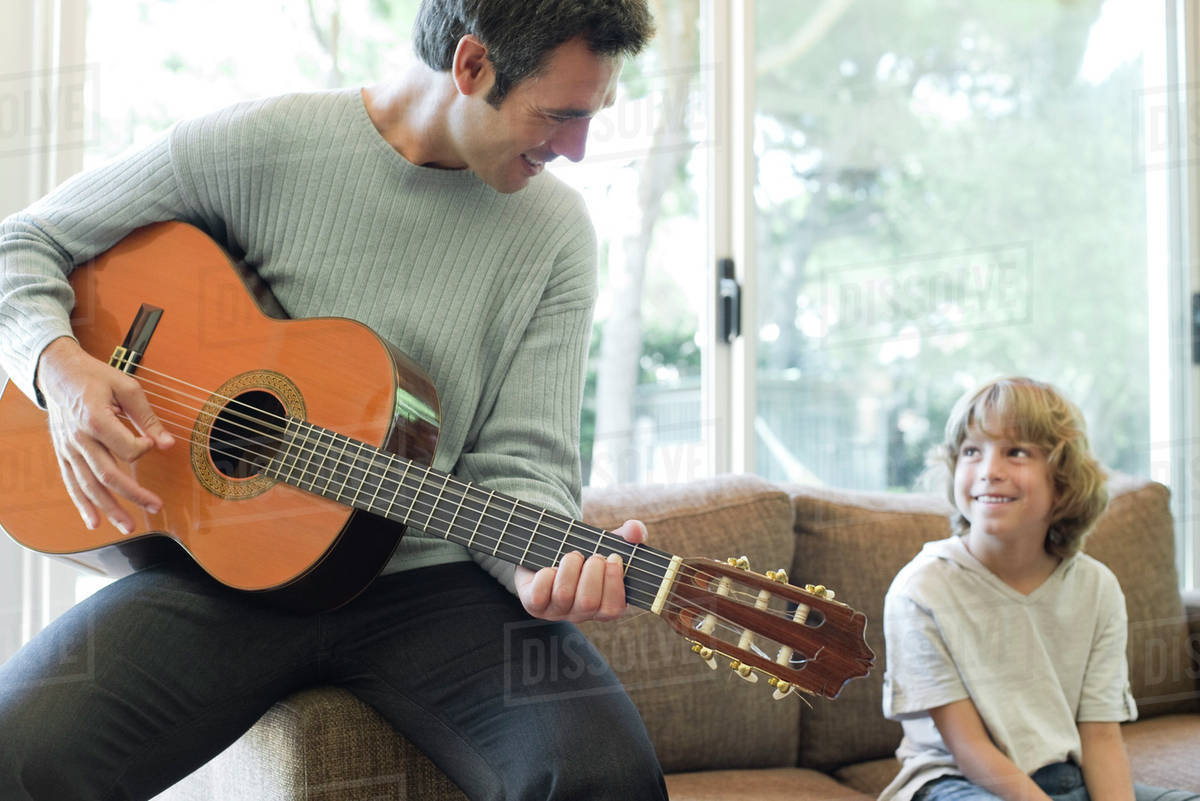 Father playing guitar for son - Royalty-free Stock Photo | Dissolve