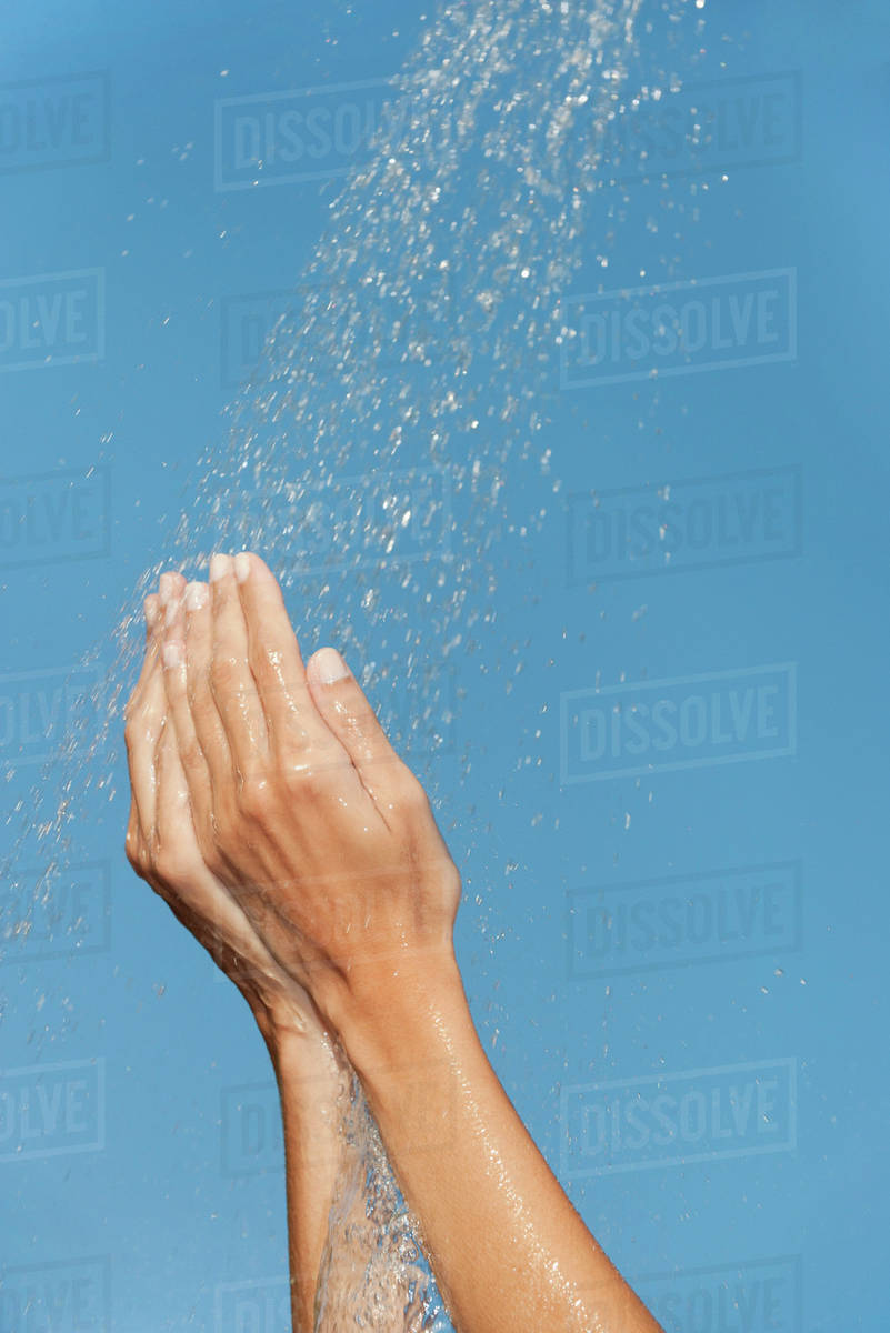 Hands under splashing water - Royalty-free Stock Photo | Dissolve