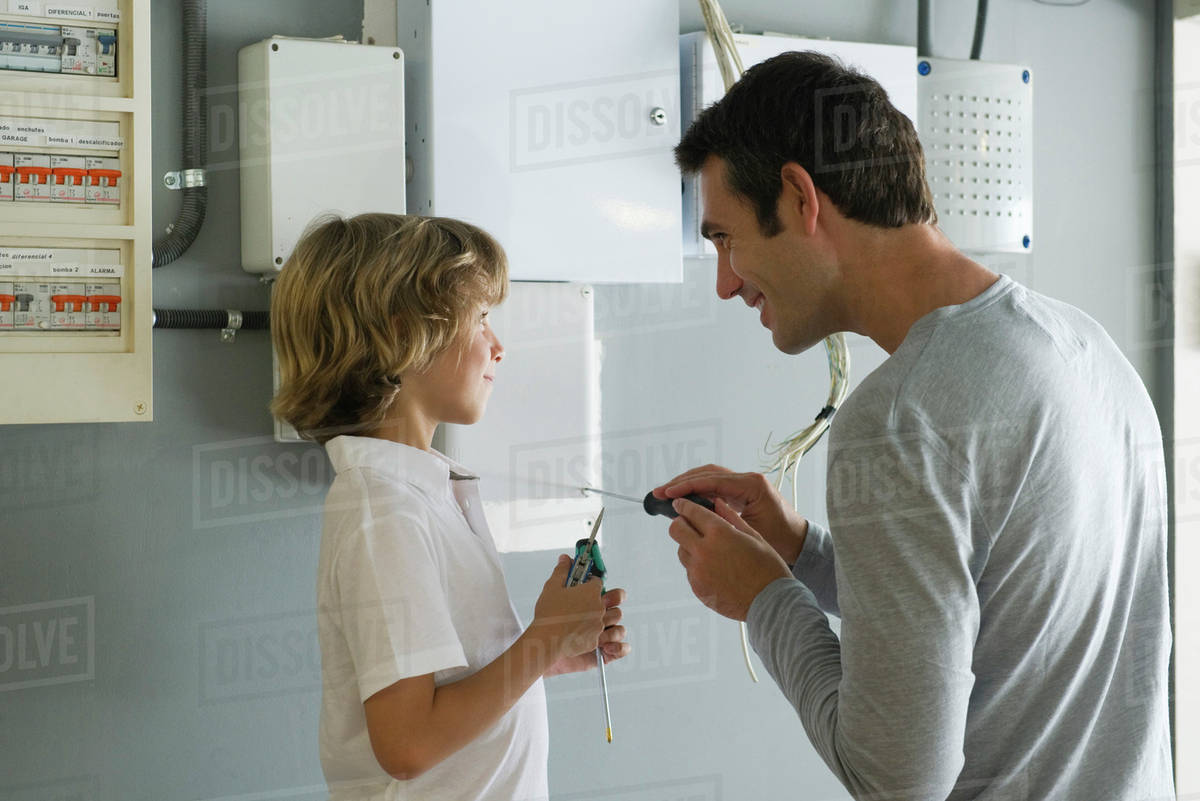 Son helping father with home improvement - Royalty-free Stock Photo ...