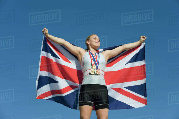 Female athlete being honored on podium, holding up British flag ...