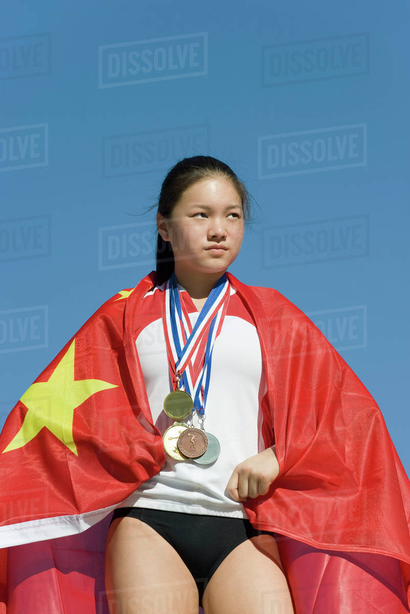 Female athlete on winner's podium, wrapped in Chinese flag - Royalty ...