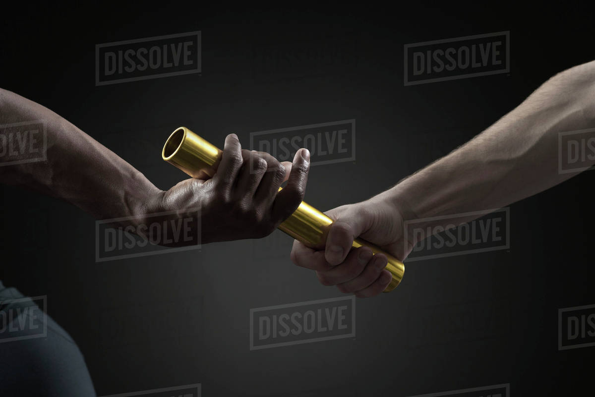 Runners passing baton, cropped - Royalty-free Stock Photo | Dissolve