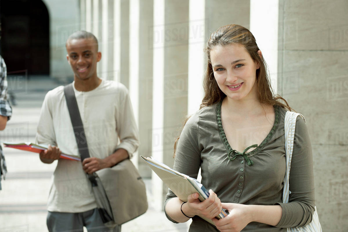 University students on campus, focus on woman in foreground - Stock ...