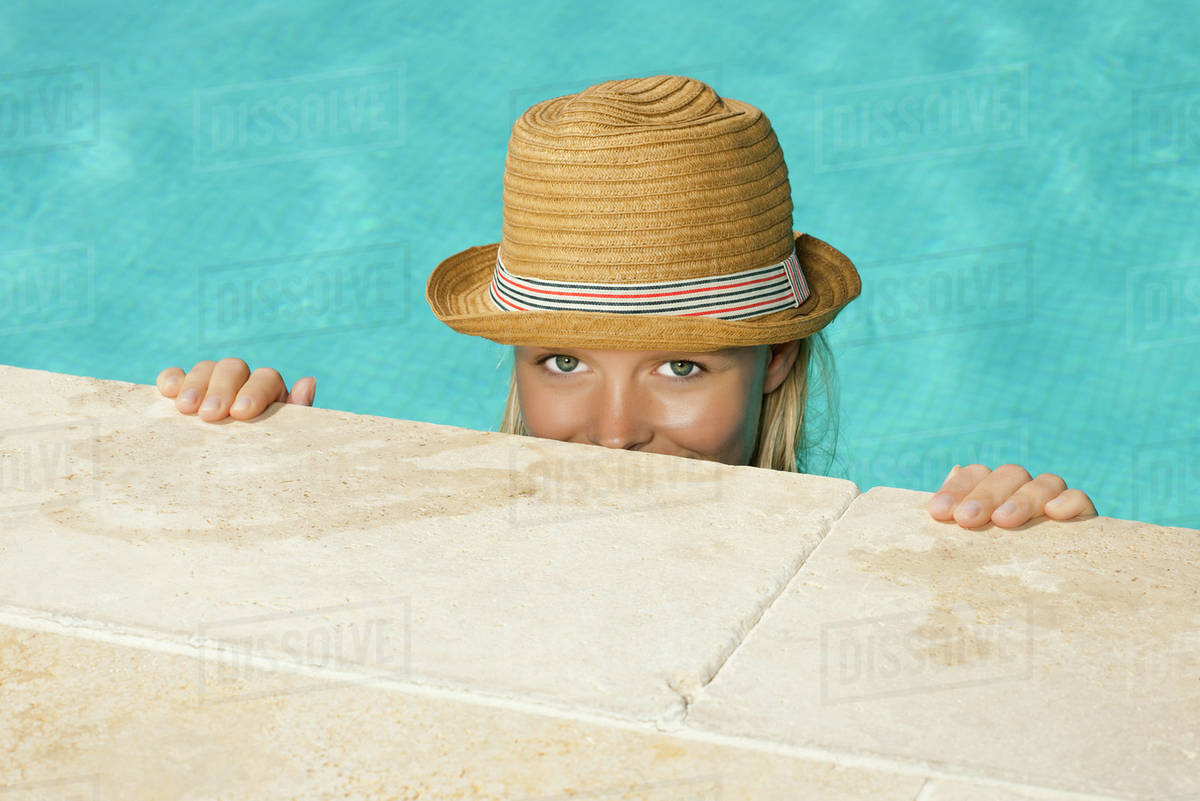 Woman in pool, peeking over edge at camera - Royalty-free Stock Photo ...