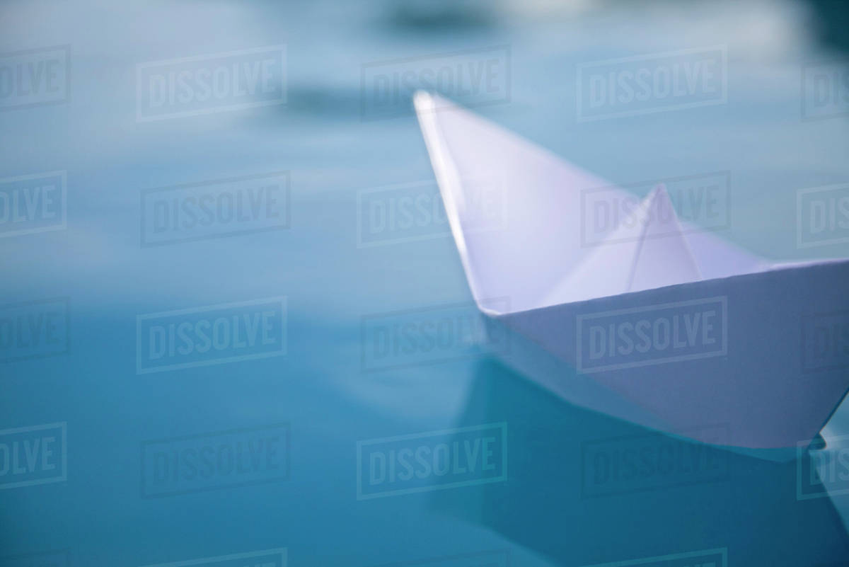 Paper boat floating on water - Royalty-free Stock Photo | Dissolve