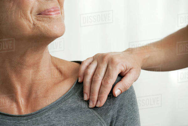Comforting hand on senior woman's shoulder, cropped - Royalty-free ...