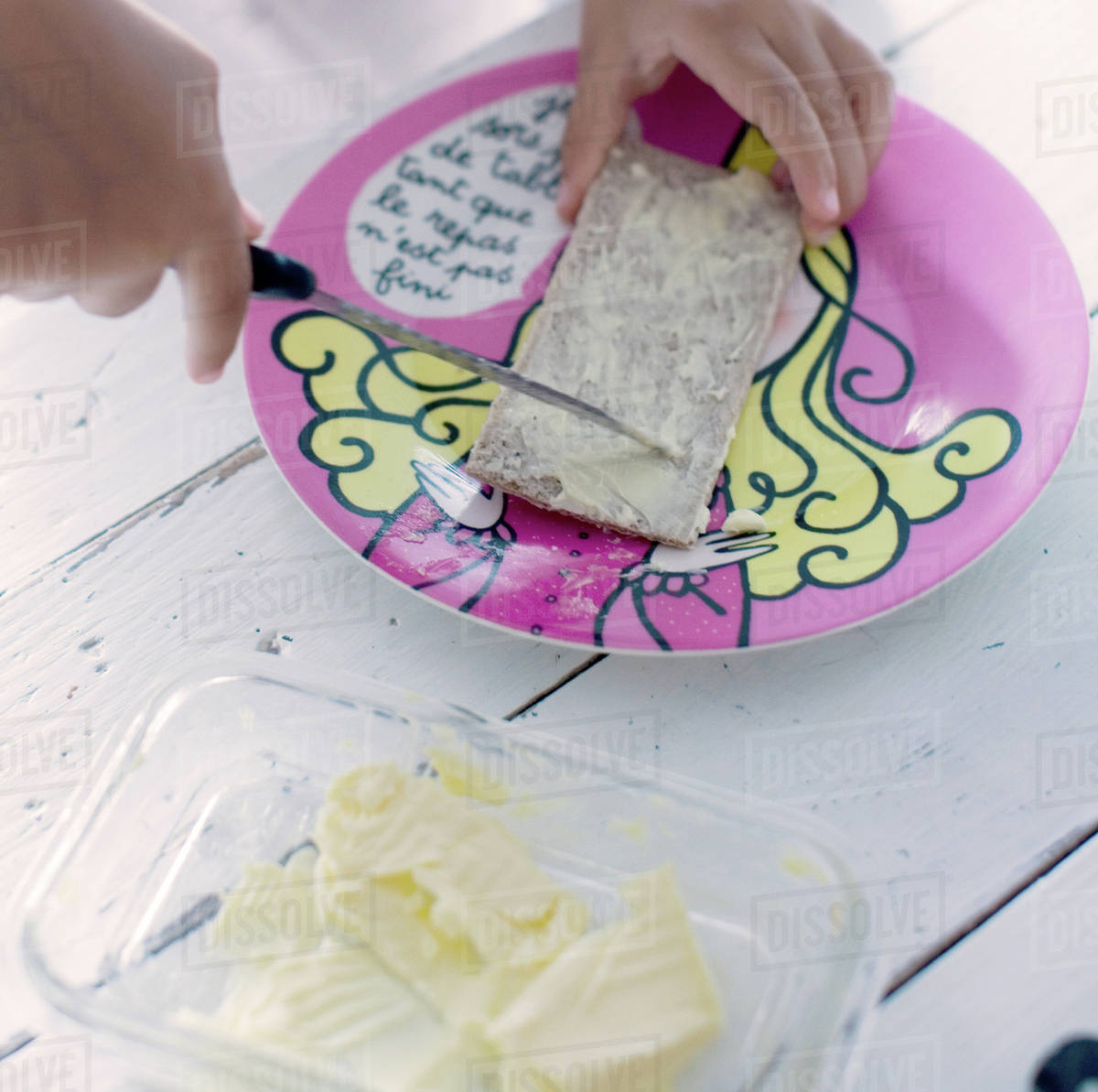 Child preparing snack, cropped - Royalty-free Stock Photo | Dissolve