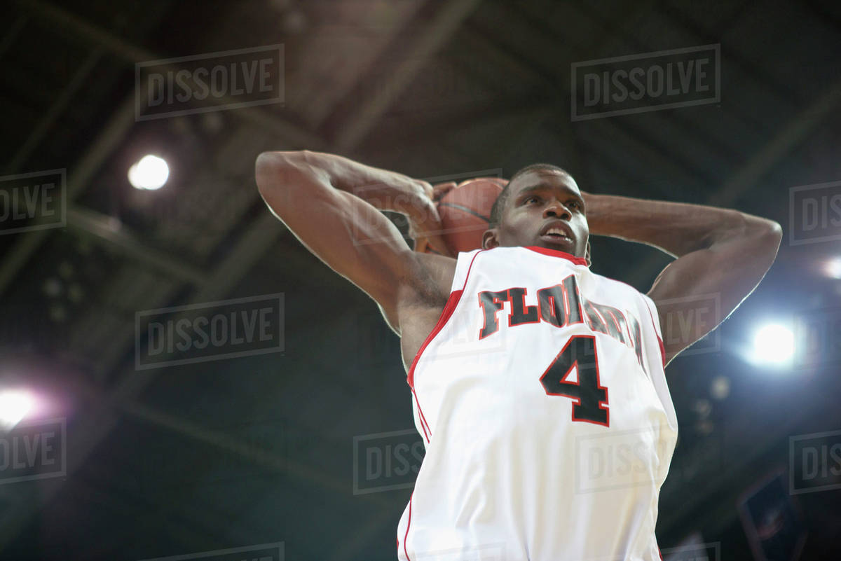 Basketball player shooting basketball, low angle view - Stock Photo ...