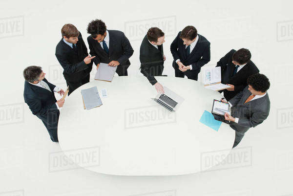 Business associates working together in pairs around table - Stock ...