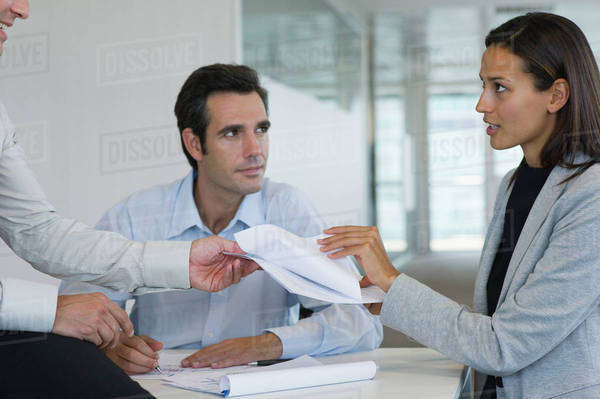 Colleagues discussing documents in meeting - Royalty-free Stock Photo ...
