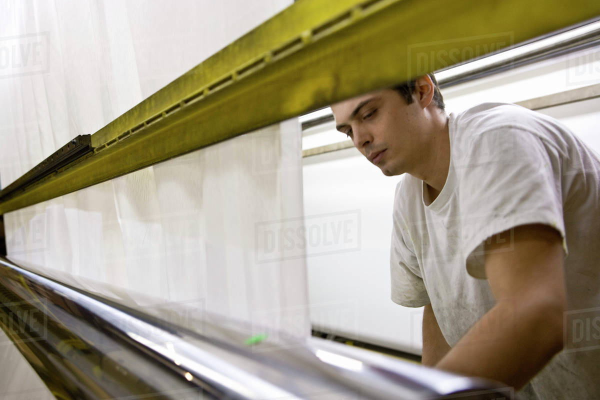 Fabric coating plant, machinist working on production line - Stock ...