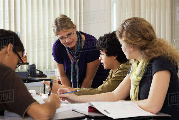 Teacher assisting high school students - Royalty-free Stock Photo ...