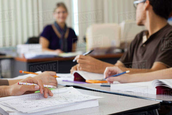 Students completing classwork, cropped - Stock Photo - Dissolve
