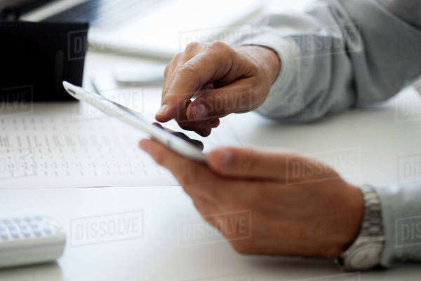 Man using touch screen on digital tablet, cropped - Stock Photo - Dissolve