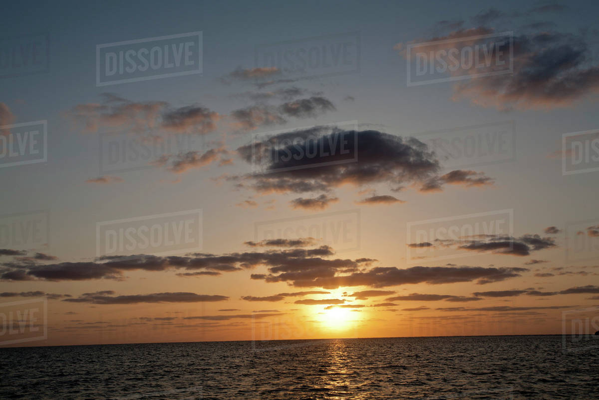 Sun setting over sea - Stock Photo - Dissolve