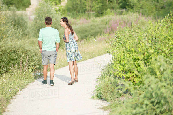 Couple together on walk through park - Royalty-free Stock Photo | Dissolve