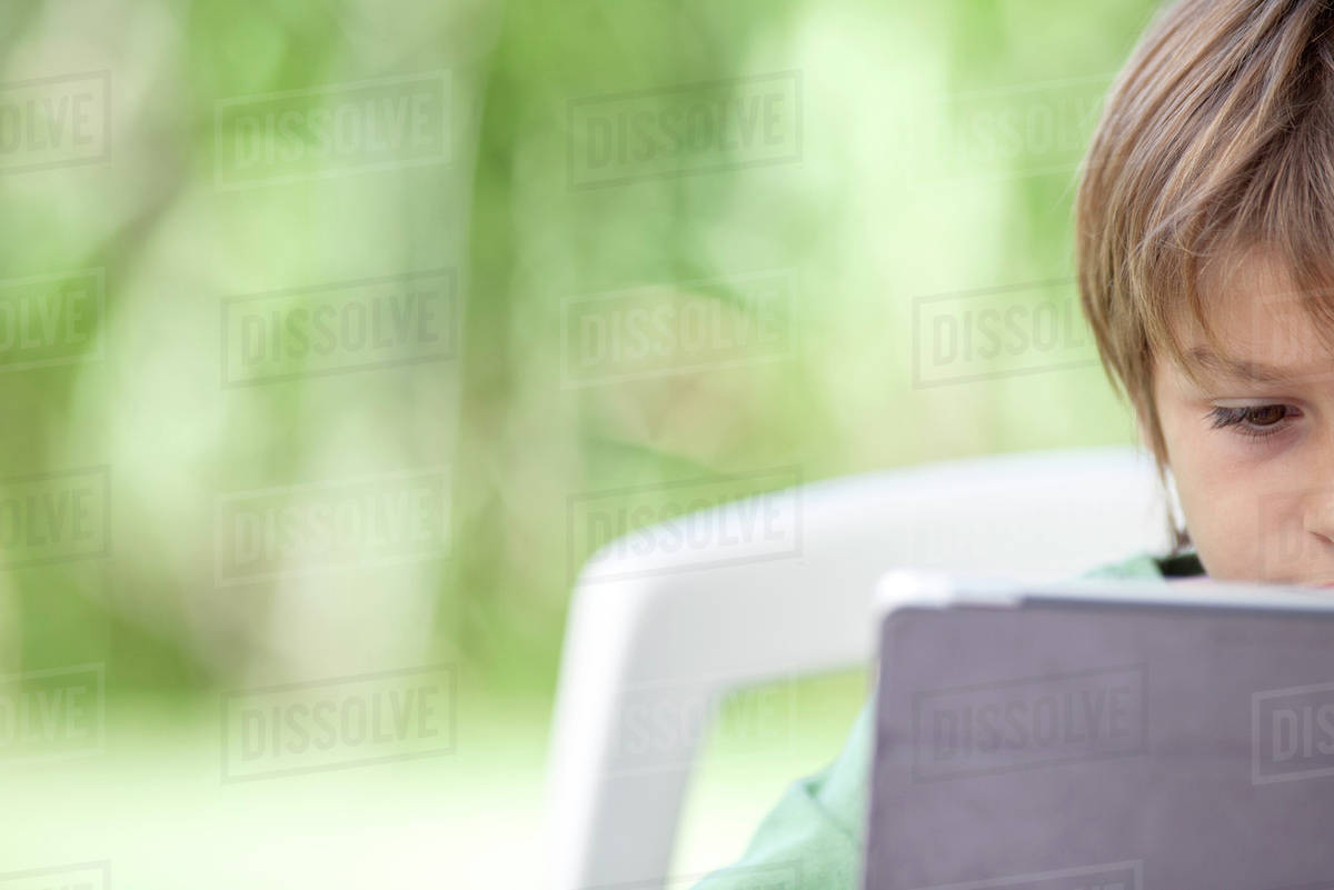 Boy using digital tablet - Royalty-free Stock Photo | Dissolve