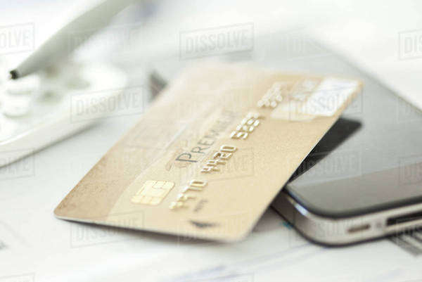 Close-up of credit card and smartphone - Stock Photo - Dissolve
