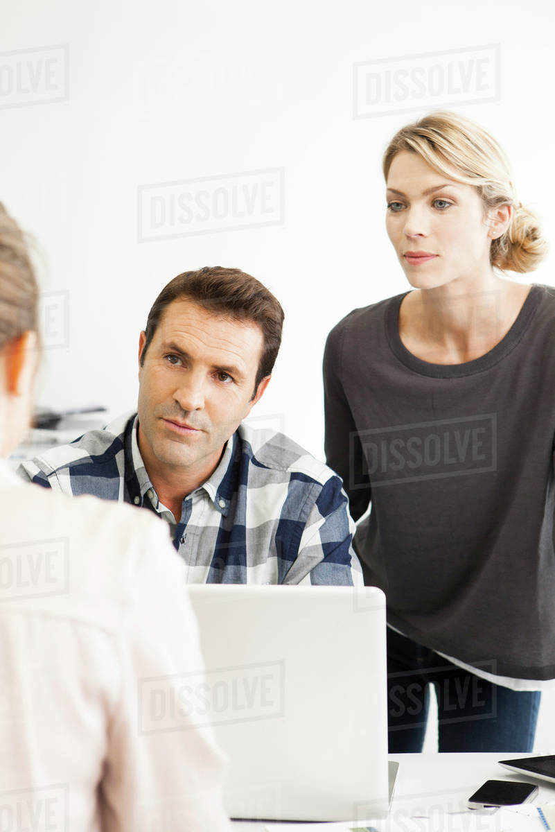 Colleagues collaborating on work project - Stock Photo - Dissolve