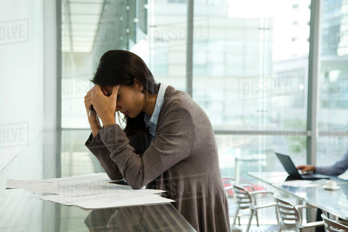 Businesswoman stressing over work - Royalty-free Stock Photo | Dissolve