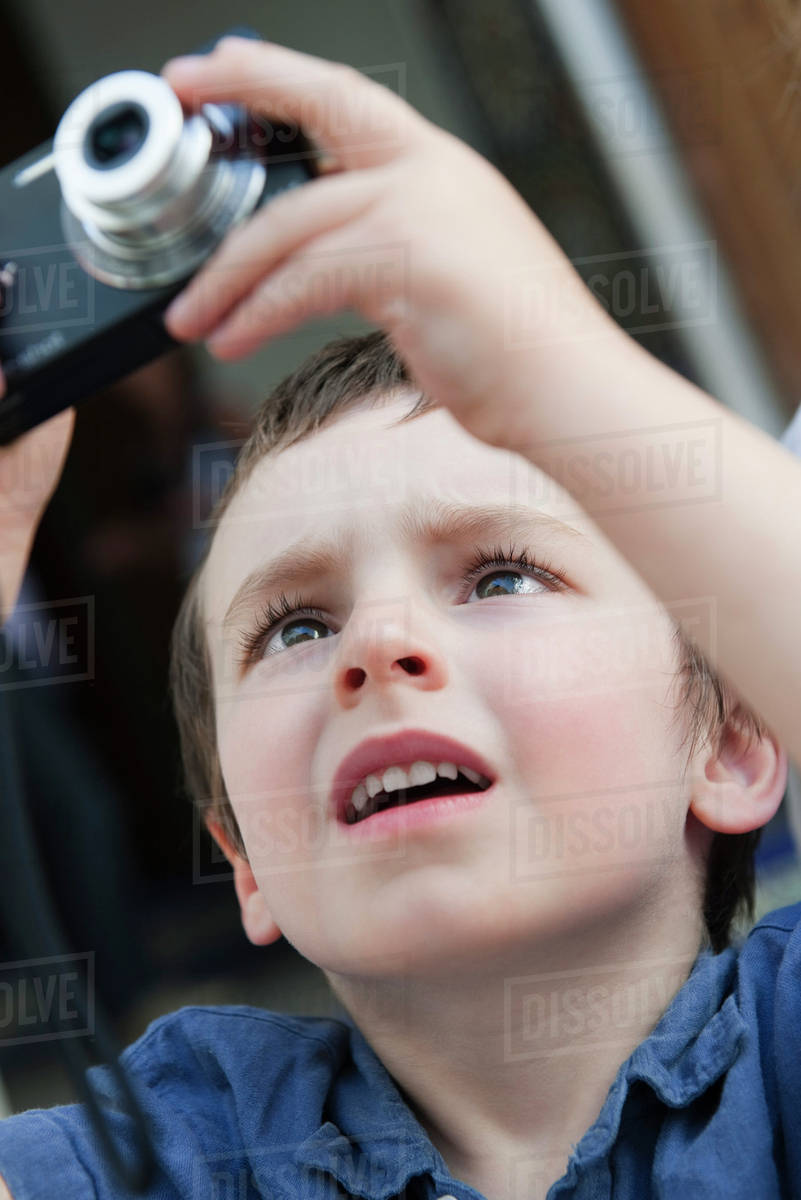 Little boy using digital camera - Royalty-free Stock Photo | Dissolve