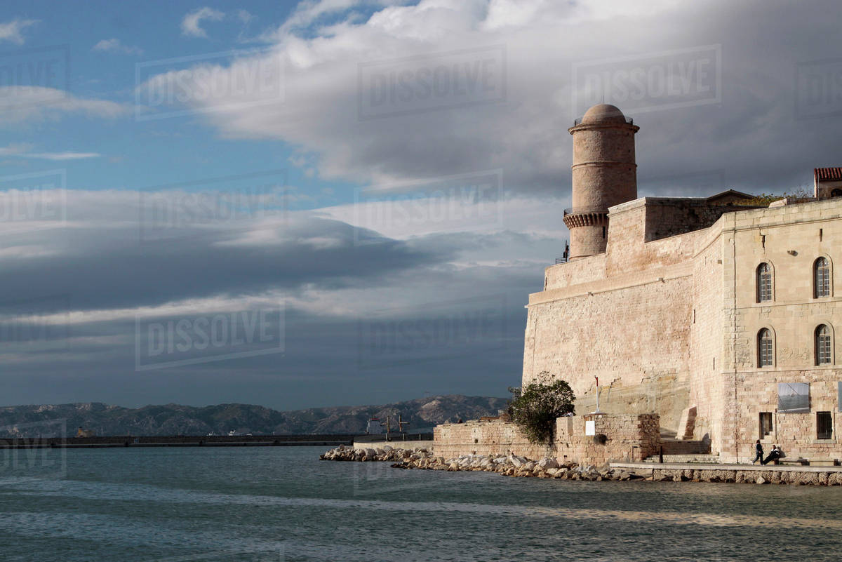 Old brick building on riverbank - Royalty-free Stock Photo | Dissolve