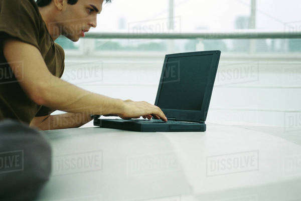 Man reclining on floor using laptop computer - Royalty-free Stock Photo ...