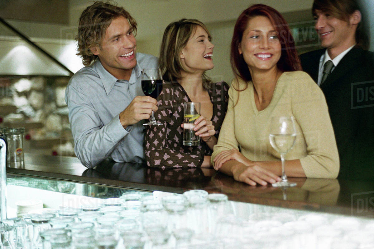 Two young couples together at bar - Royalty-free Stock Photo | Dissolve