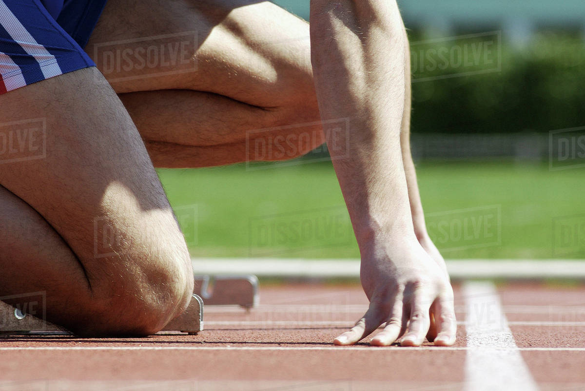 Runner crouching at starting line, cropped - Royalty-free Stock Photo ...