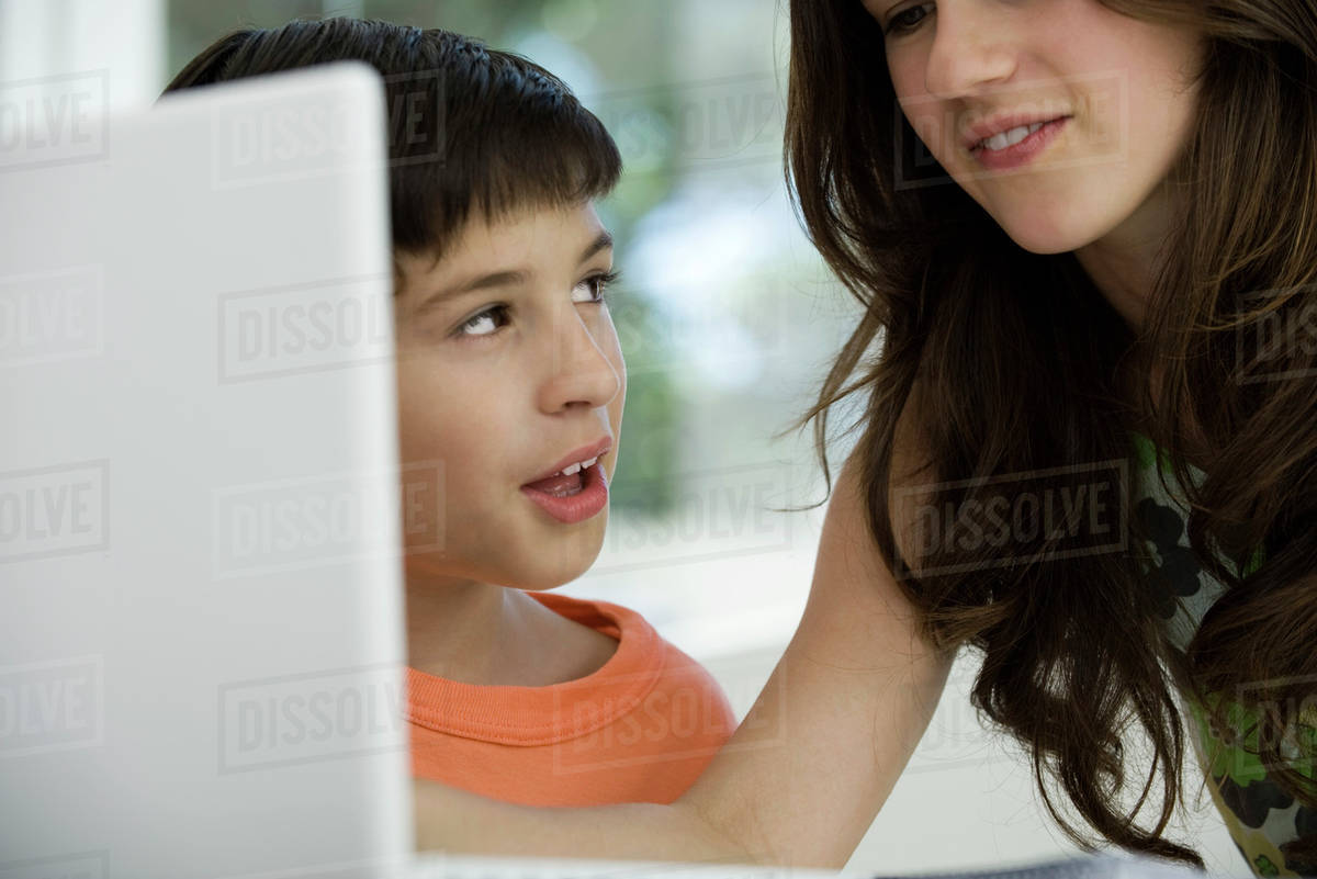 Sister and younger brother using laptop computer together - Royalty ...