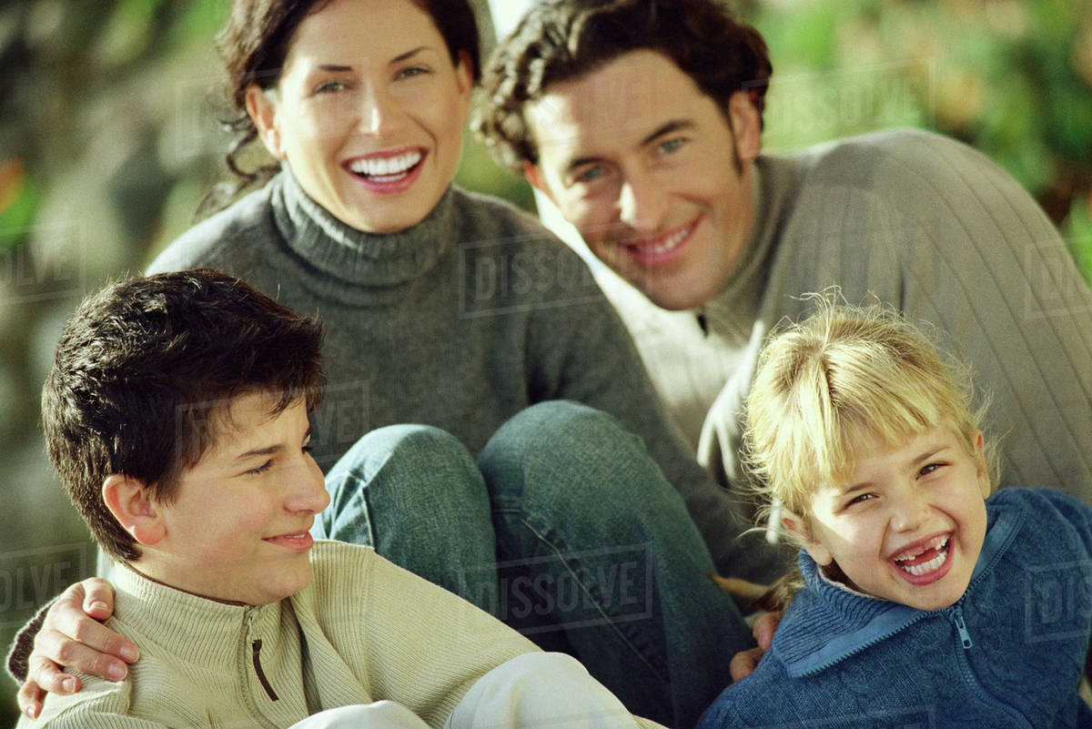 Family laughing together outdoors - Royalty-free Stock Photo | Dissolve