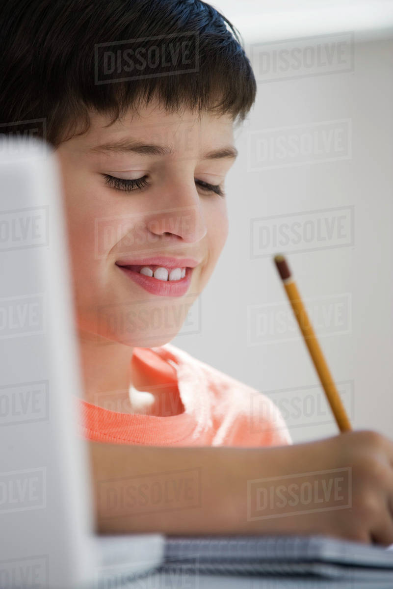 Elementary school student writing classwork - Royalty-free Stock Photo ...