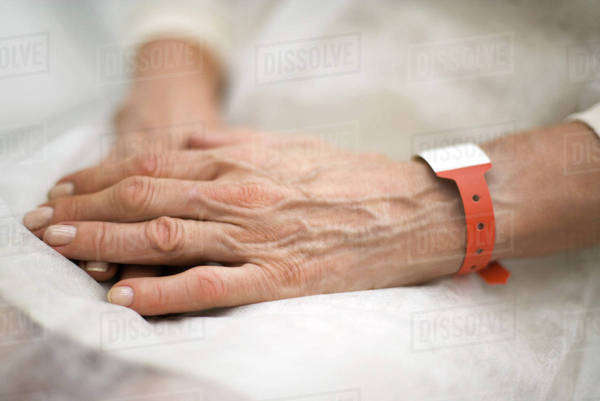 Hospital patient's hands folded in lap, close-up - Royalty-free Stock ...