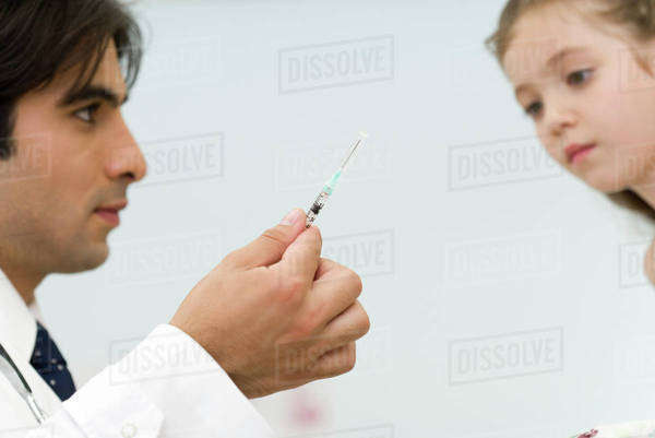 Pediatrician showing little girl syringe - Royalty-free Stock Photo ...