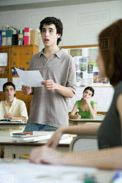 High school student giving presentation in class - Stock Photo - Dissolve