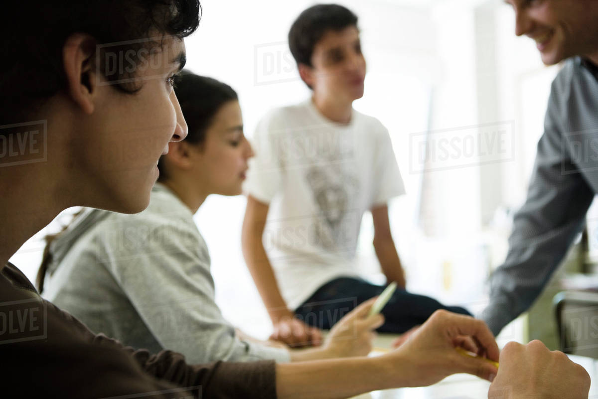 High school students chatting with teacher after class - Stock Photo ...