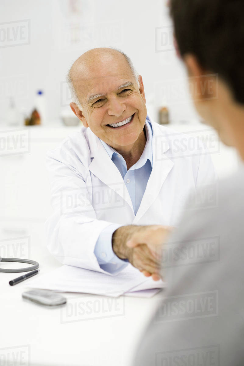 Doctor shaking patient's hand - Royalty-free Stock Photo | Dissolve