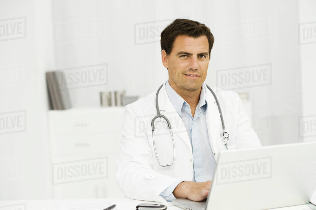 Doctor using laptop computer, portrait - Royalty-free Stock Photo ...