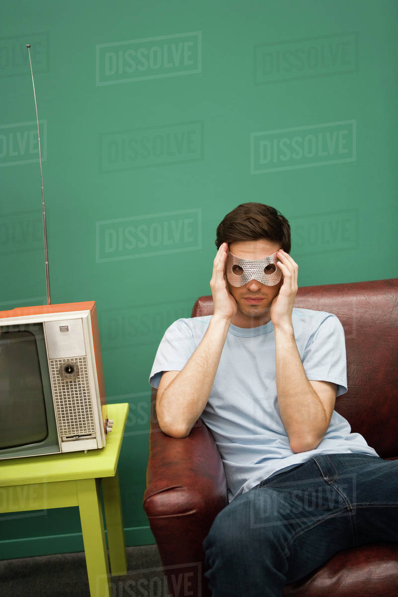 Man concealing identity behind mask - Royalty-free Stock Photo | Dissolve